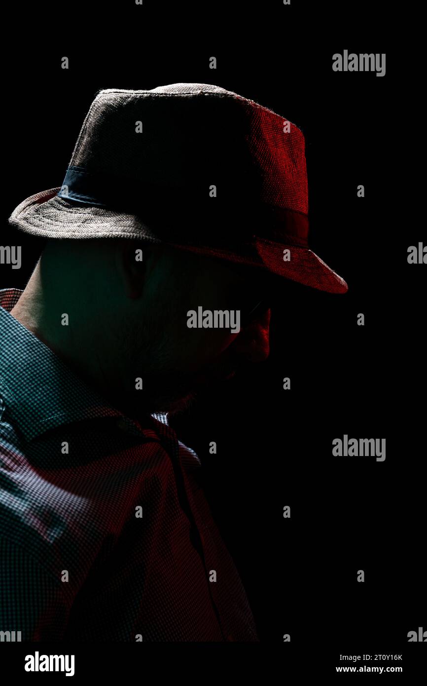 Mysterious man wearing hat and sunglasses. Portrait in dark studio ...