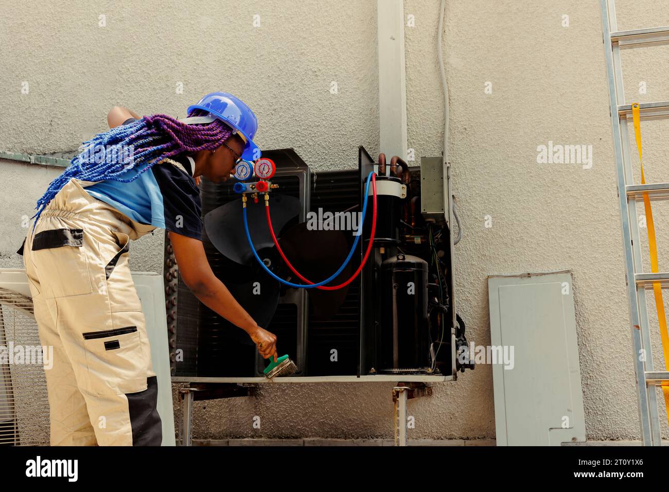 African american worker sweeping away loose debris accumulated around ...