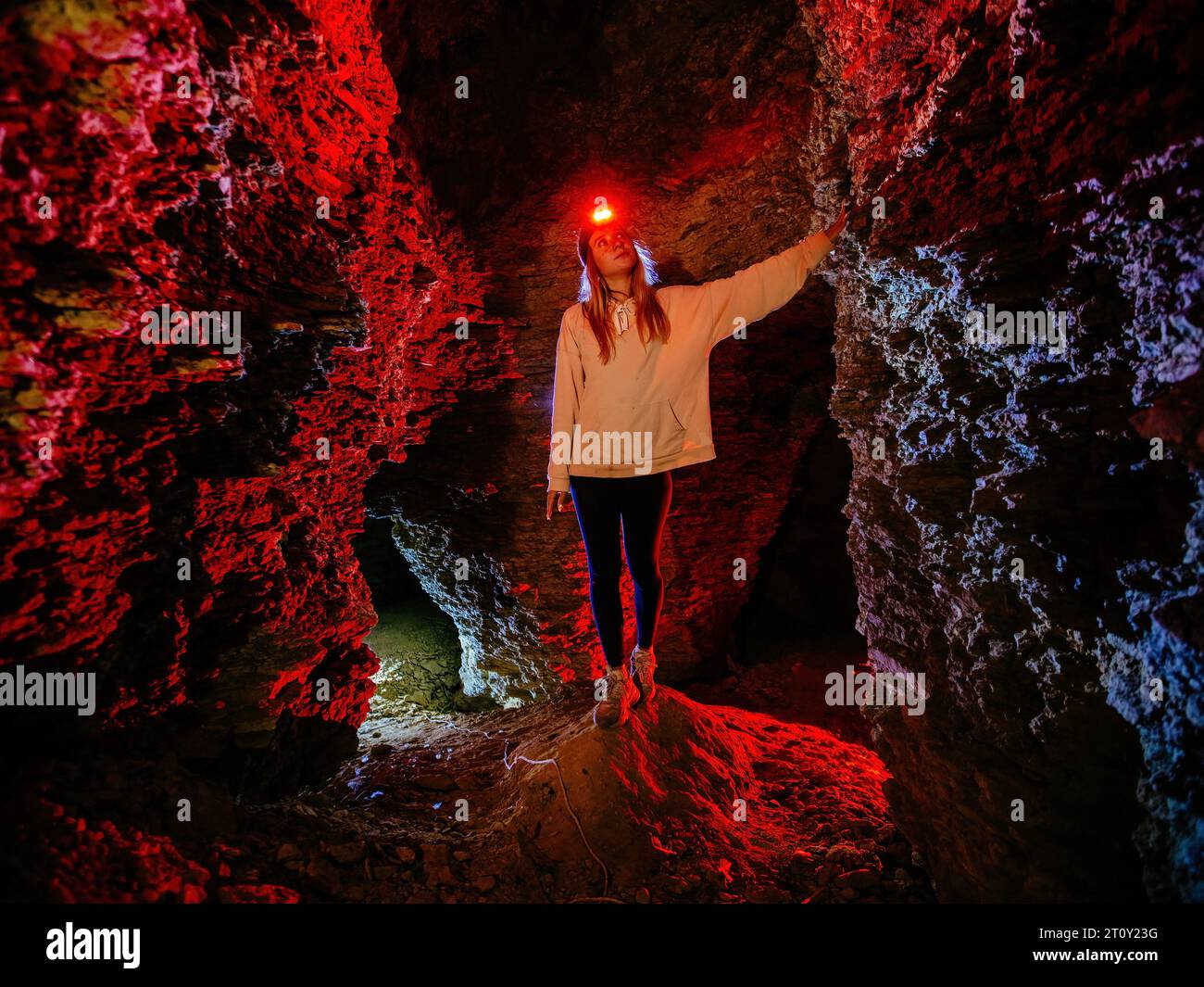 Girl with flashlight explores dark creepy abandoned underground ...