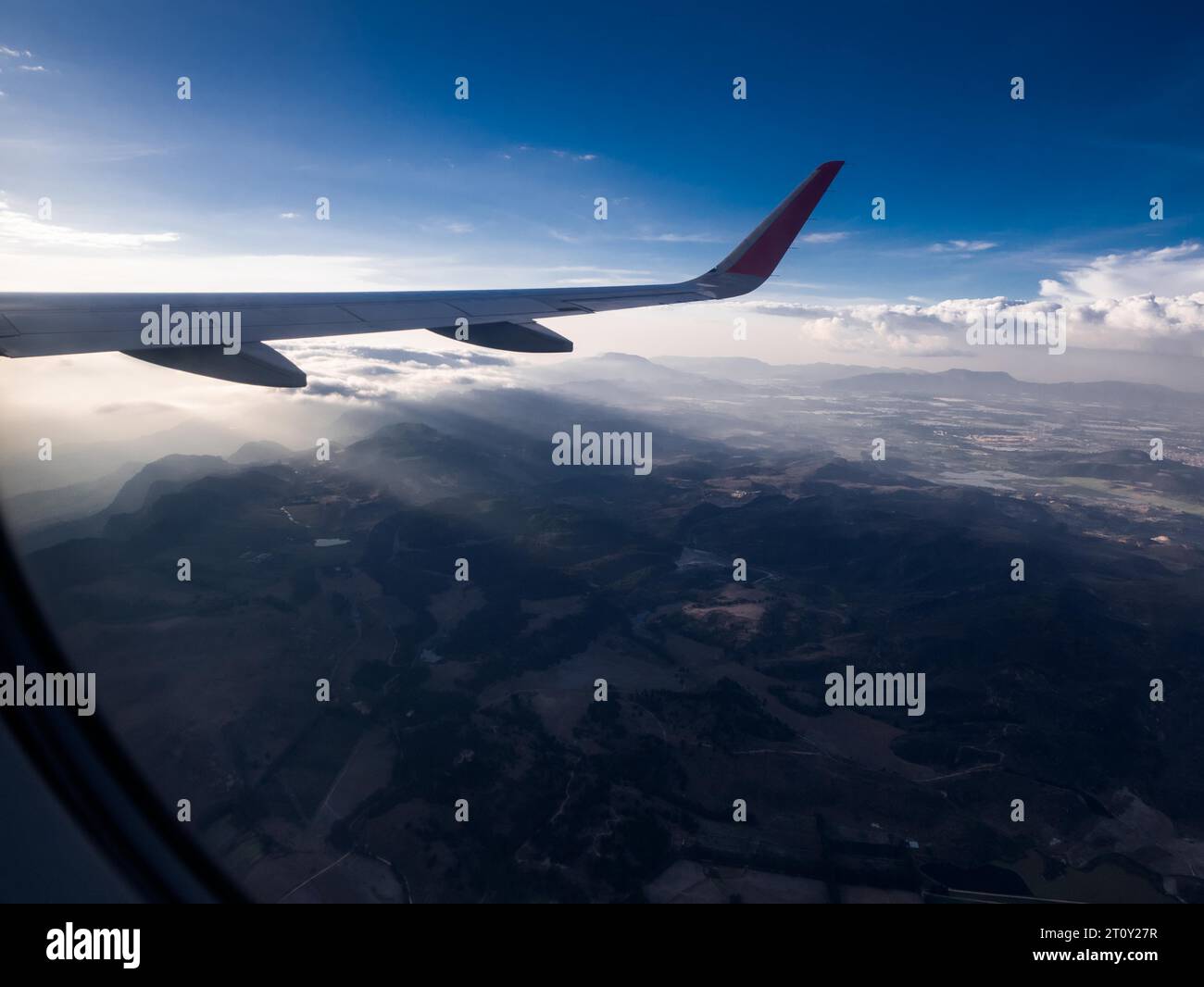 view thru the window of a passanger jet airplane flying from Bogotá ...