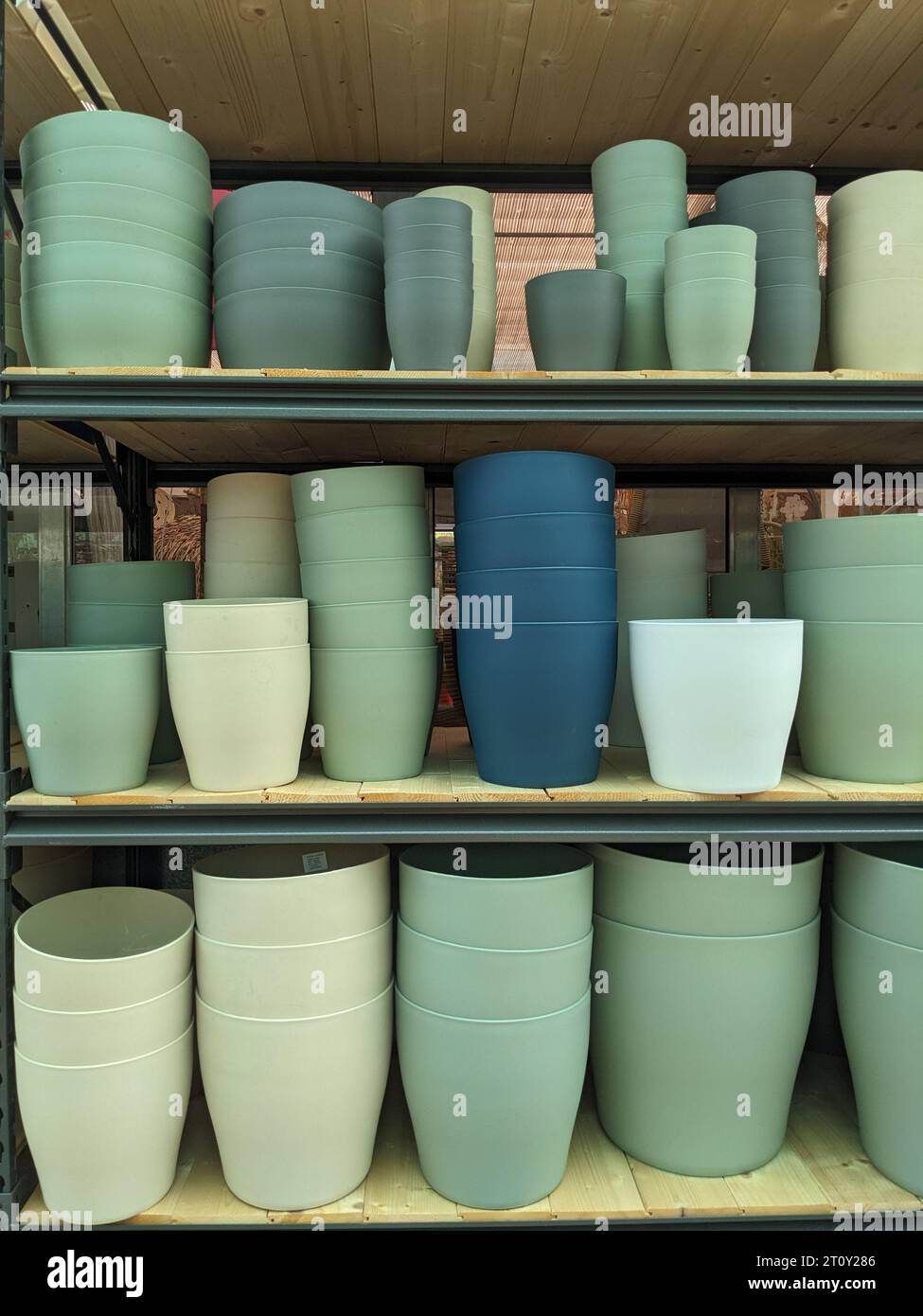 Colorful recycled plastic pots displayed for sale. Concept of recycled ...