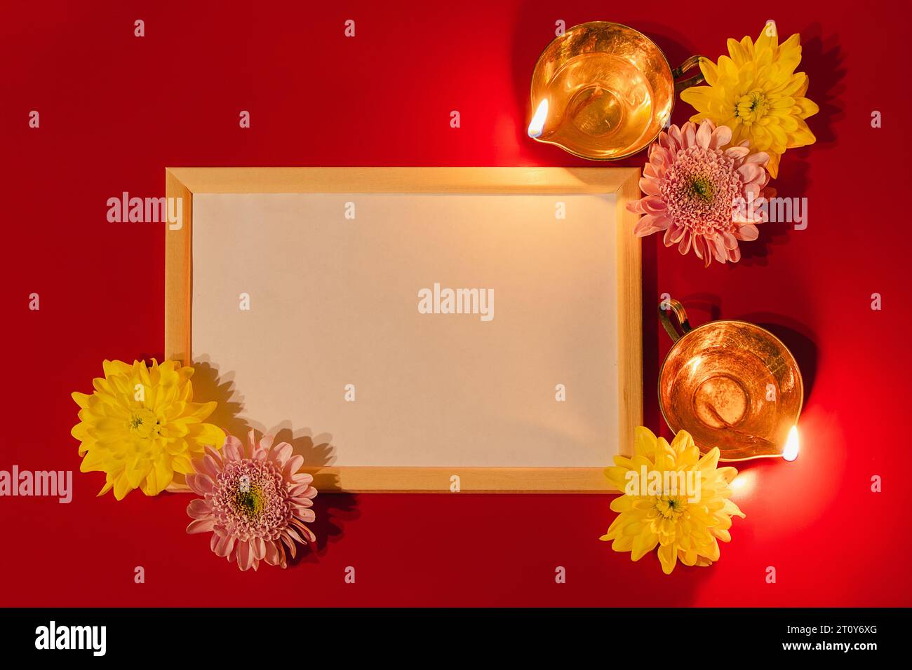 Happy Diwali. Diya oil lamp and flowers on red background. Celebrating ...