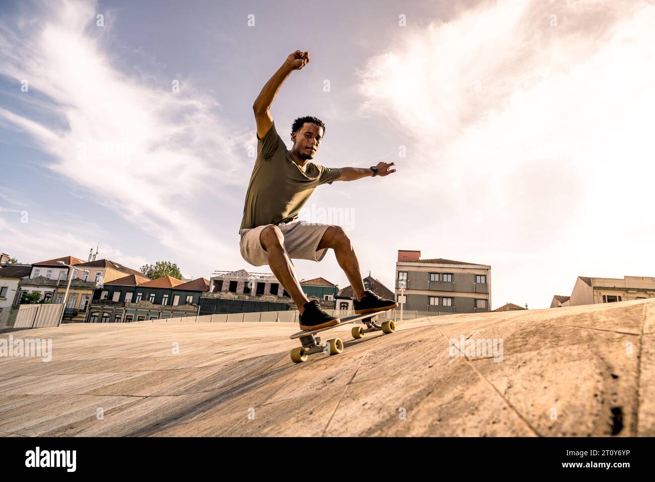Surf skater training surfing moves on a urban scene Stock Photo - Alamy
