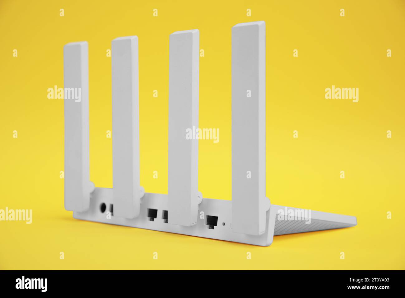 One modern Wi-Fi router on yellow background Stock Photo - Alamy