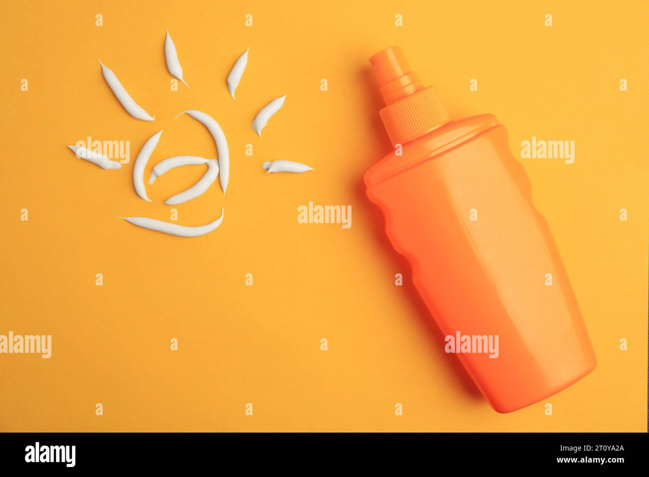 Drawing of sun and bottle with sunscreen on orange background, top view ...