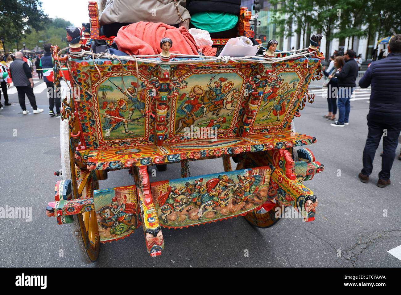 Decorated horses pulling carts with people and wine move up 5th Avenue ...