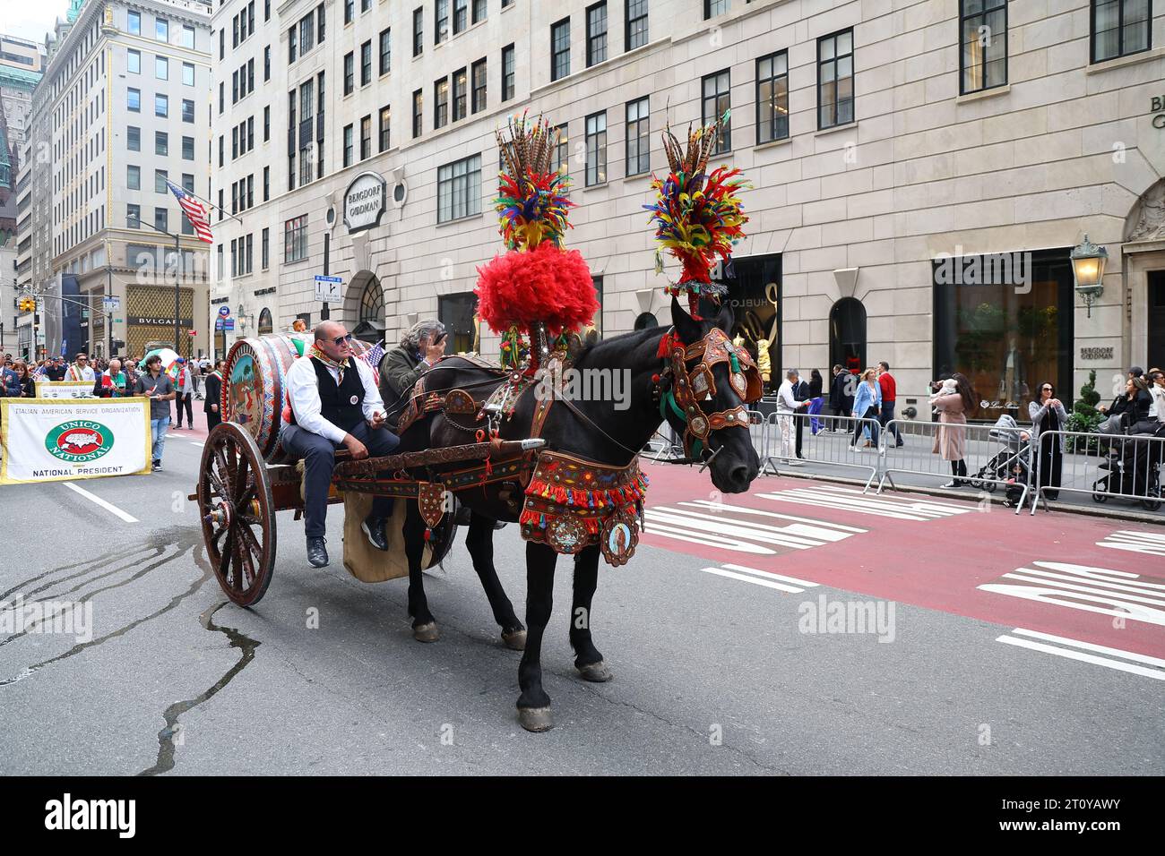 Decorated horses pulling carts with people and wine move up 5th Avenue ...