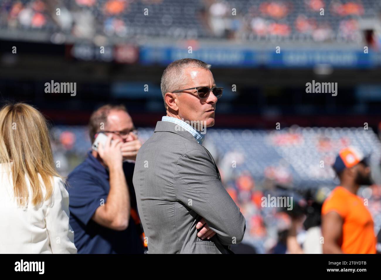 Denver Broncos chief executive officer Greg Penner looks on as players ...