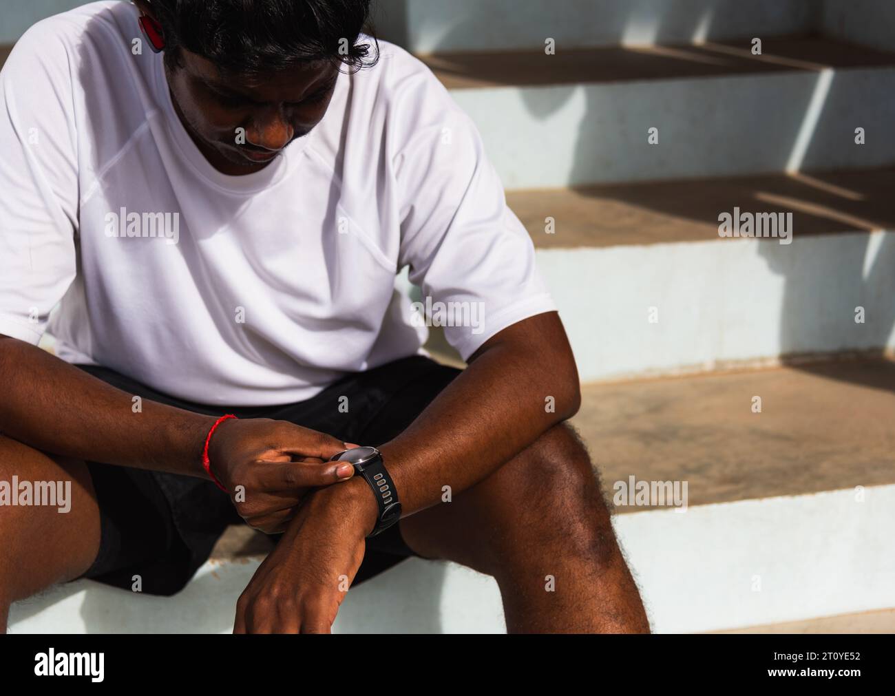 sport runner black man wear modern time smart watch he sitting resting ...