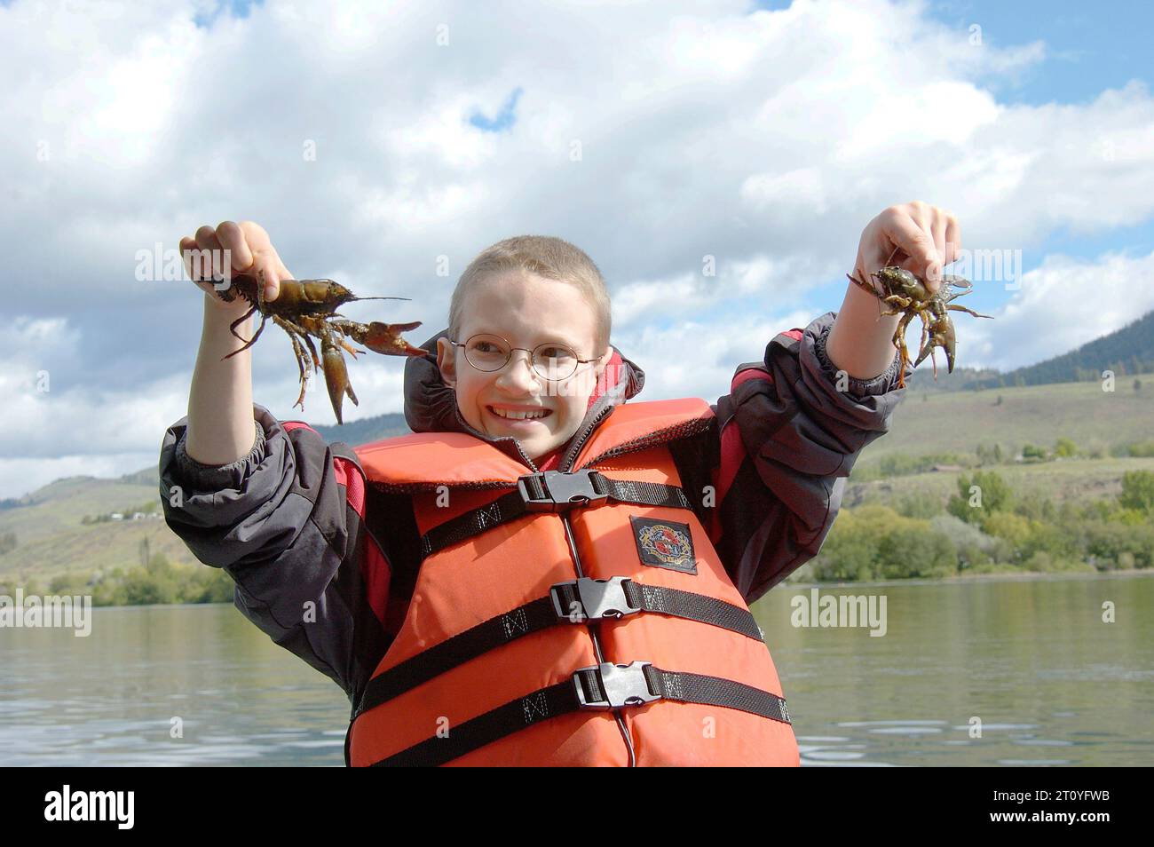 Josh Rigg displays a crawfish he trapped in a Washington lake Stock ...