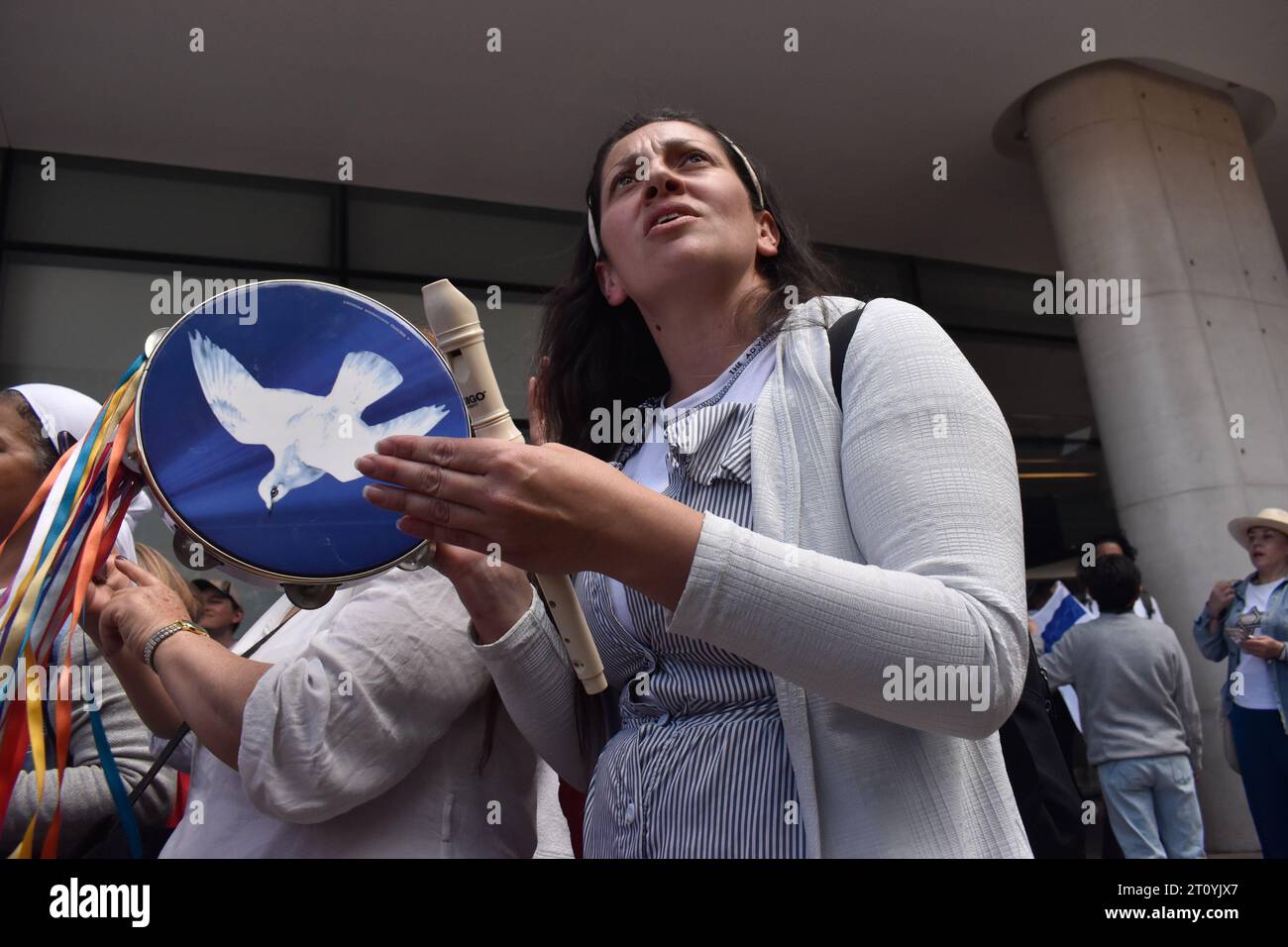Bogota, Colombia. 09th Oct, 2023. A women holds an image od a white ...
