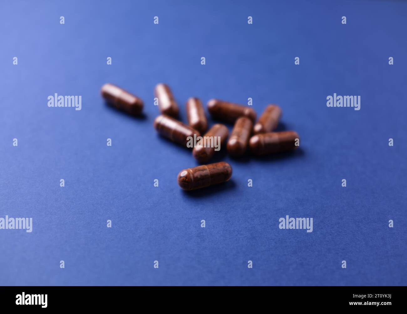 Ashwagandha (Withania somnifera) capsules. Paper background. Soft focus ...