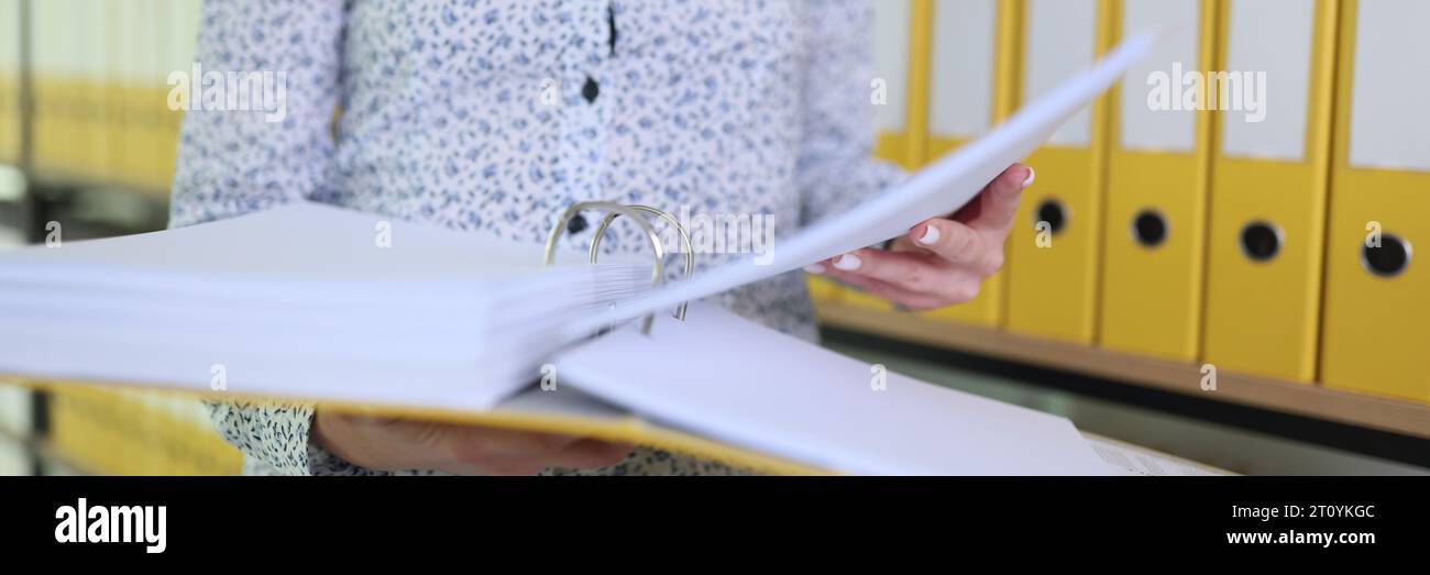 Accountant looks for documents running through files Stock Photo - Alamy