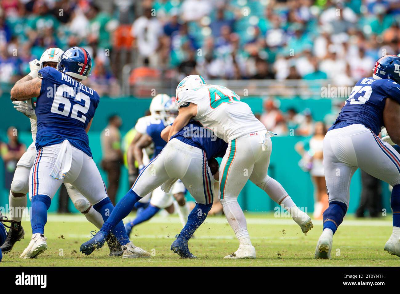 Miami Dolphins linebacker Andrew Van Ginkel (43) puts a hit on New York ...