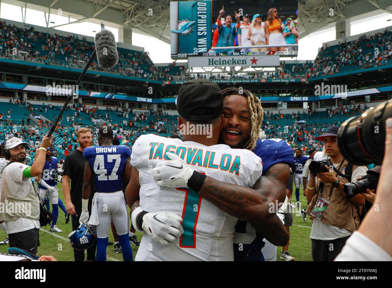 New York Giants safety Xavier McKinney (29) greets Miami Dolphins quarterback Tua Tagovailoa (1 ...