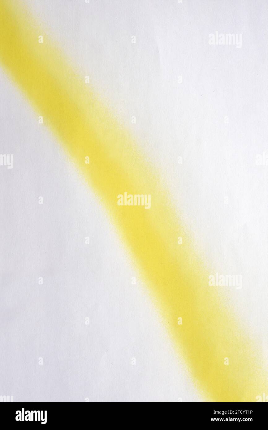 spray painted yellow diagonal line on white paper background Stock ...