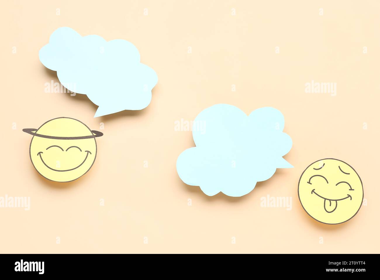 Paper faces with blank speech bubbles on beige background Stock Photo ...