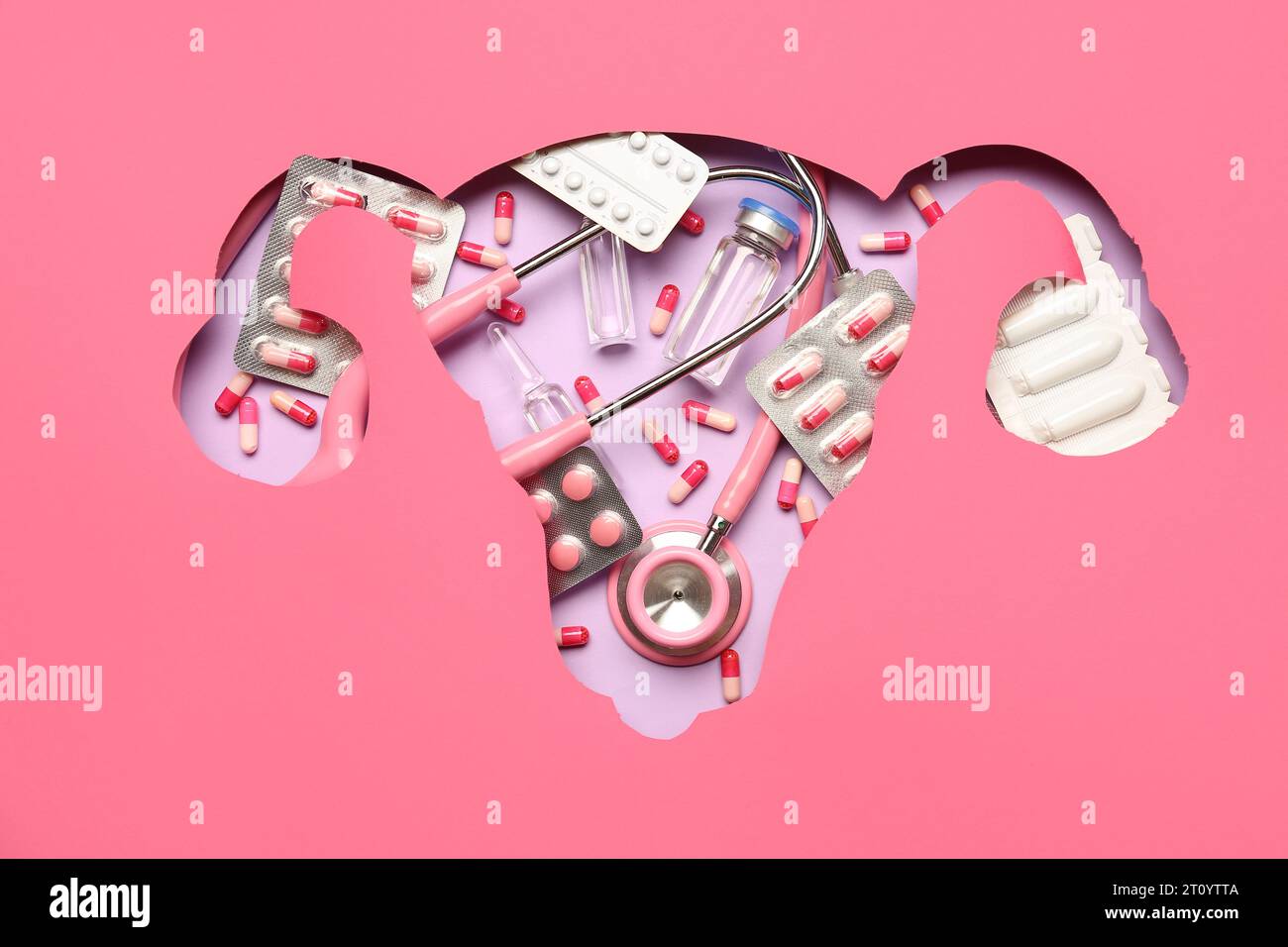 Hormonal medications visible through cut pink paper in shape of uterus ...