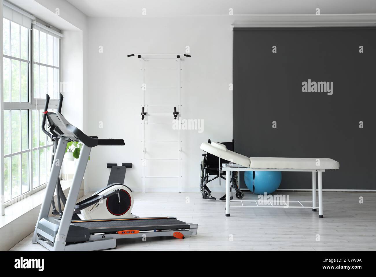 Interior of rehabilitation center with couch and equipment Stock Photo ...
