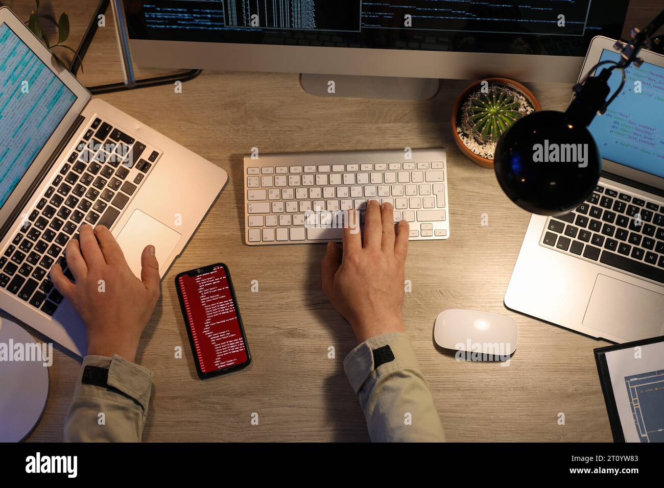 Male programmer working in office at night, top view Stock Photo - Alamy