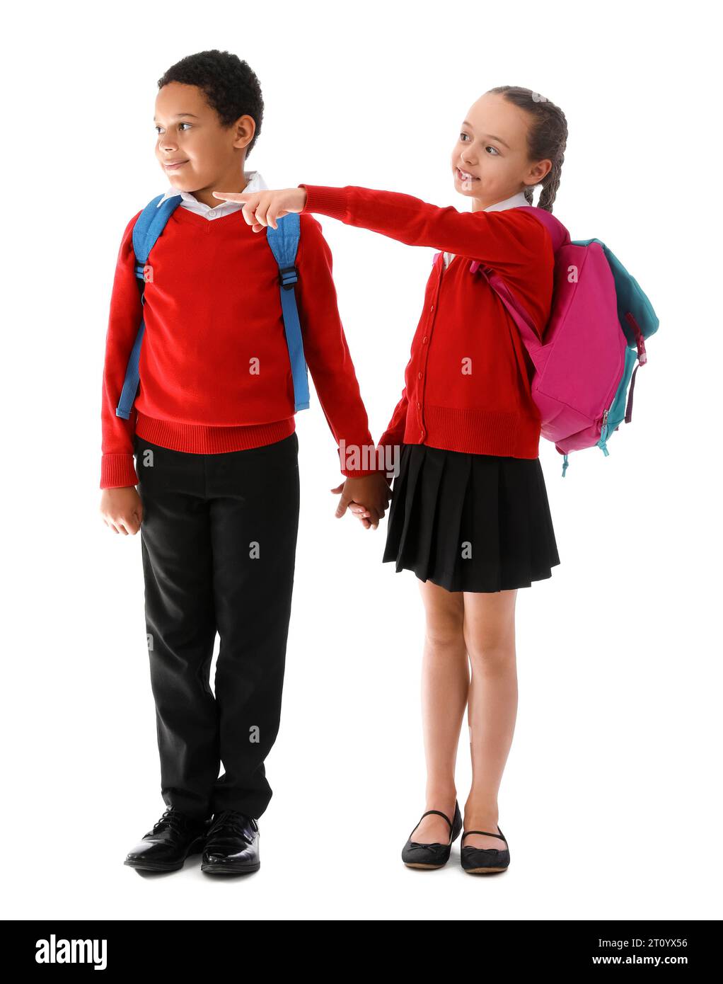 Little classmates in stylish uniform with backpacks pointing at ...