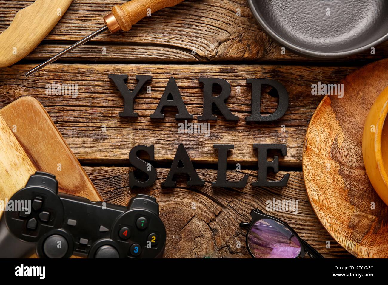 Text YARD SALE made of letters with unwanted stuff on brown wooden ...