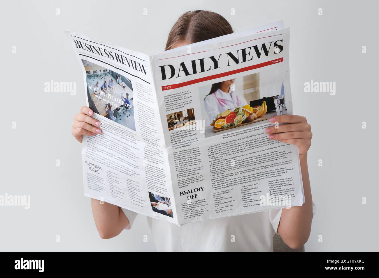 Woman reading morning newspaper on white background Stock Photo - Alamy
