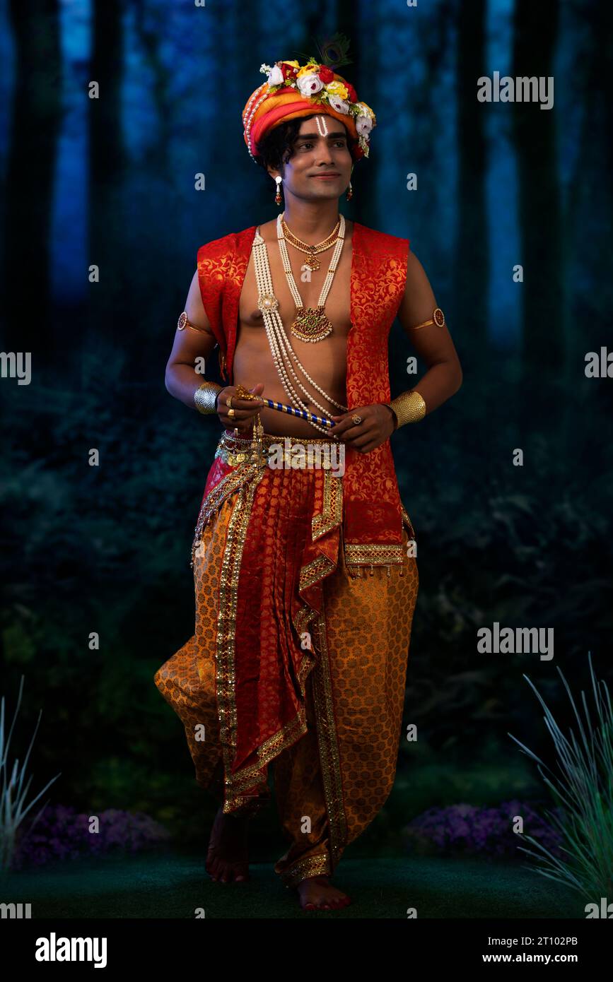 Young man dressed up as Lord Krishna on the occasion of Janmashtami ...