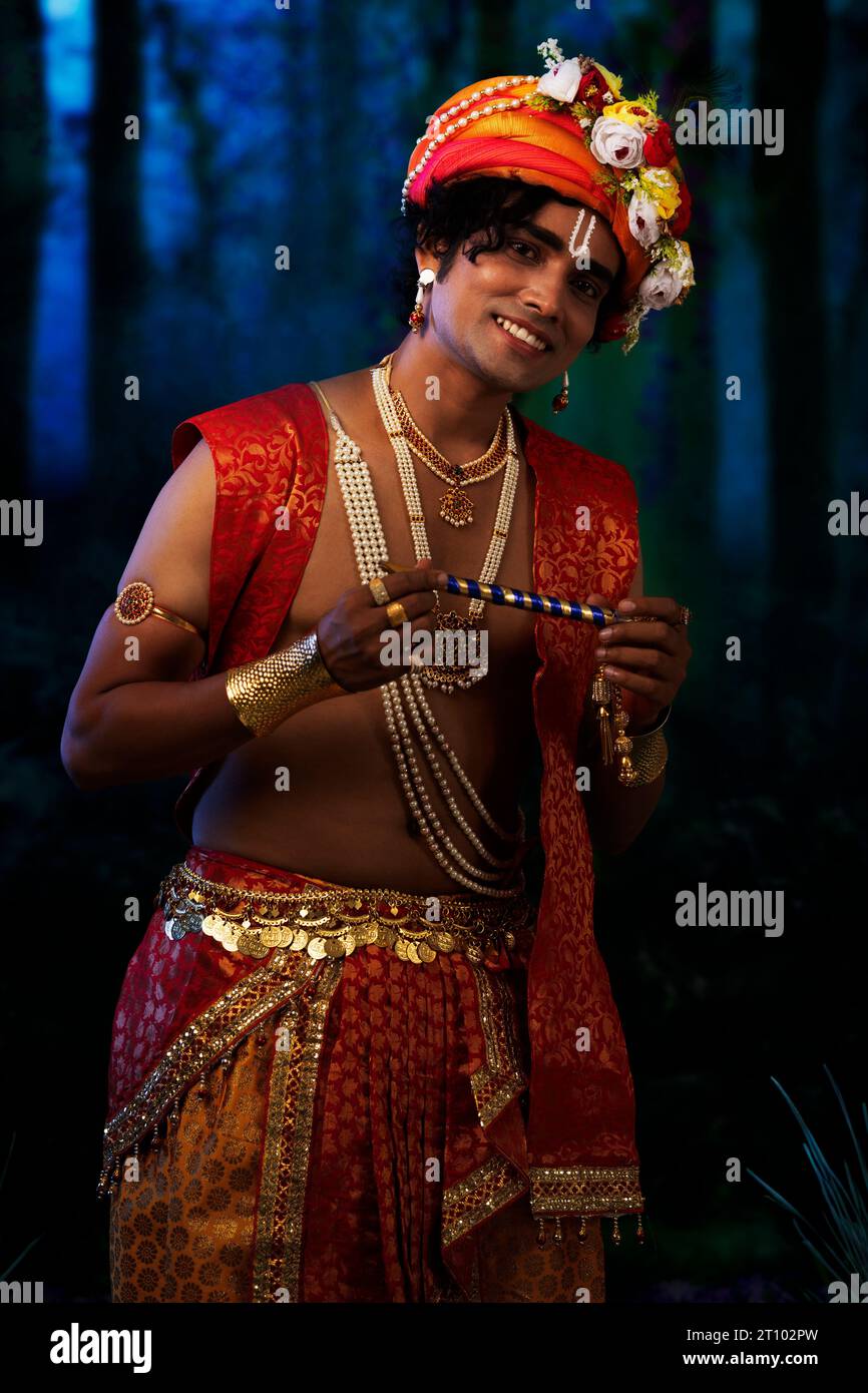 Young man dressed up as Lord Krishna on the occasion of Janmashtami ...