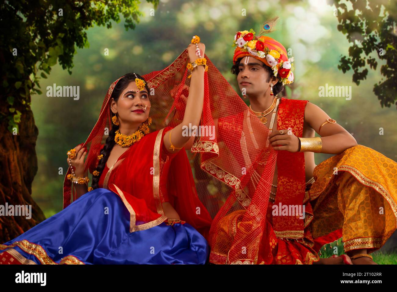 Young man and woman dressed up as Radha and Krishna and romancing on ...