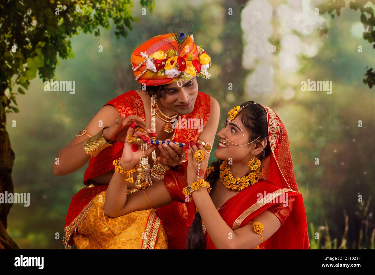 Young man and woman dressed up as Radha and Krishna and romancing on ...