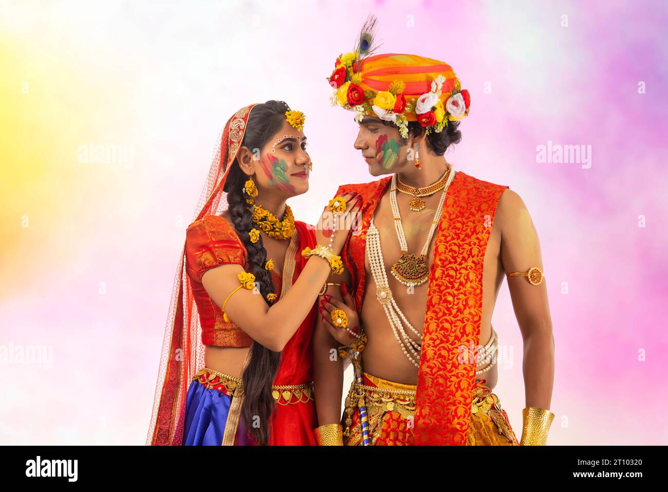 Young man and woman dressed up as Lord Radha and Krishna and performing ...