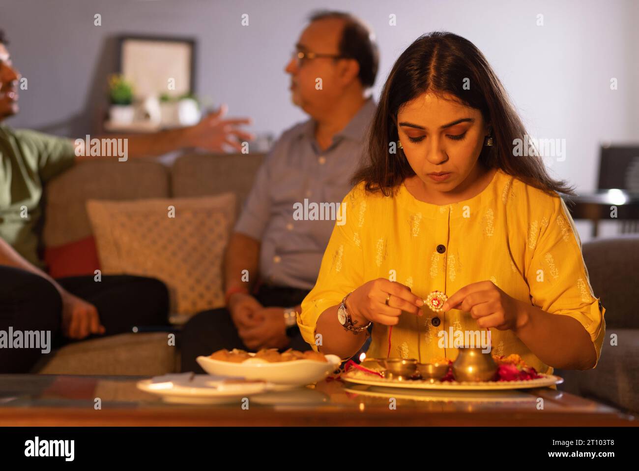 Young woman arranging puja thali on the occasion of Raksha Bandhan ...