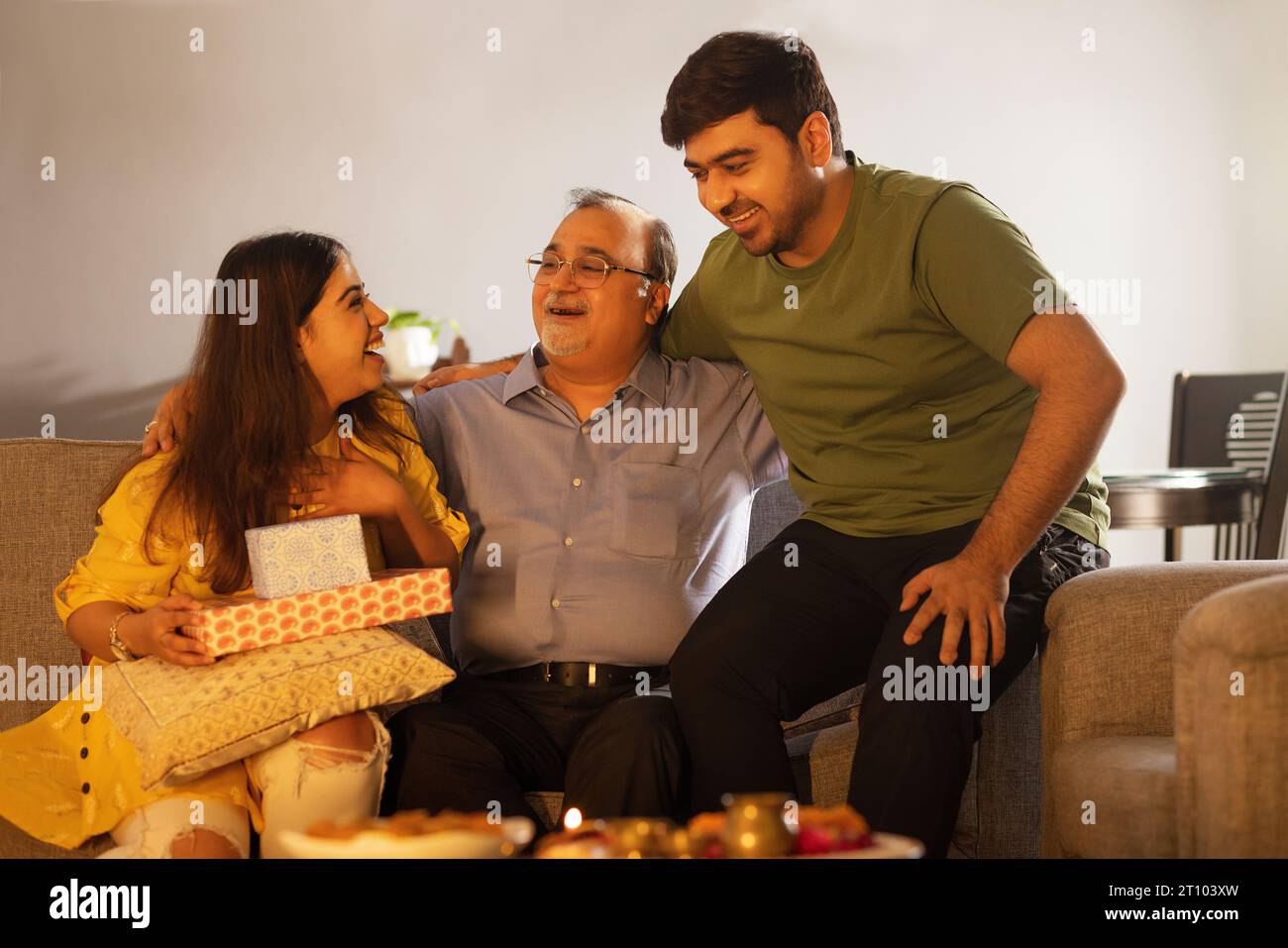 Indian family sitting together at home and talking to each other on ...