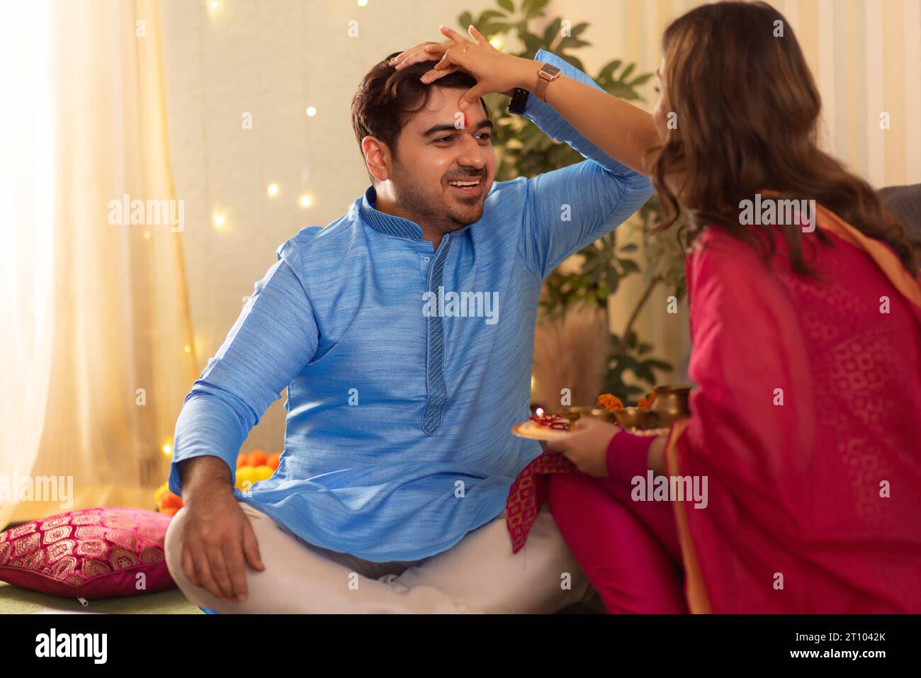 Sister applying tilaka on her brother's forehead on the occasion of Raksha Bandhan Stock Photo ...