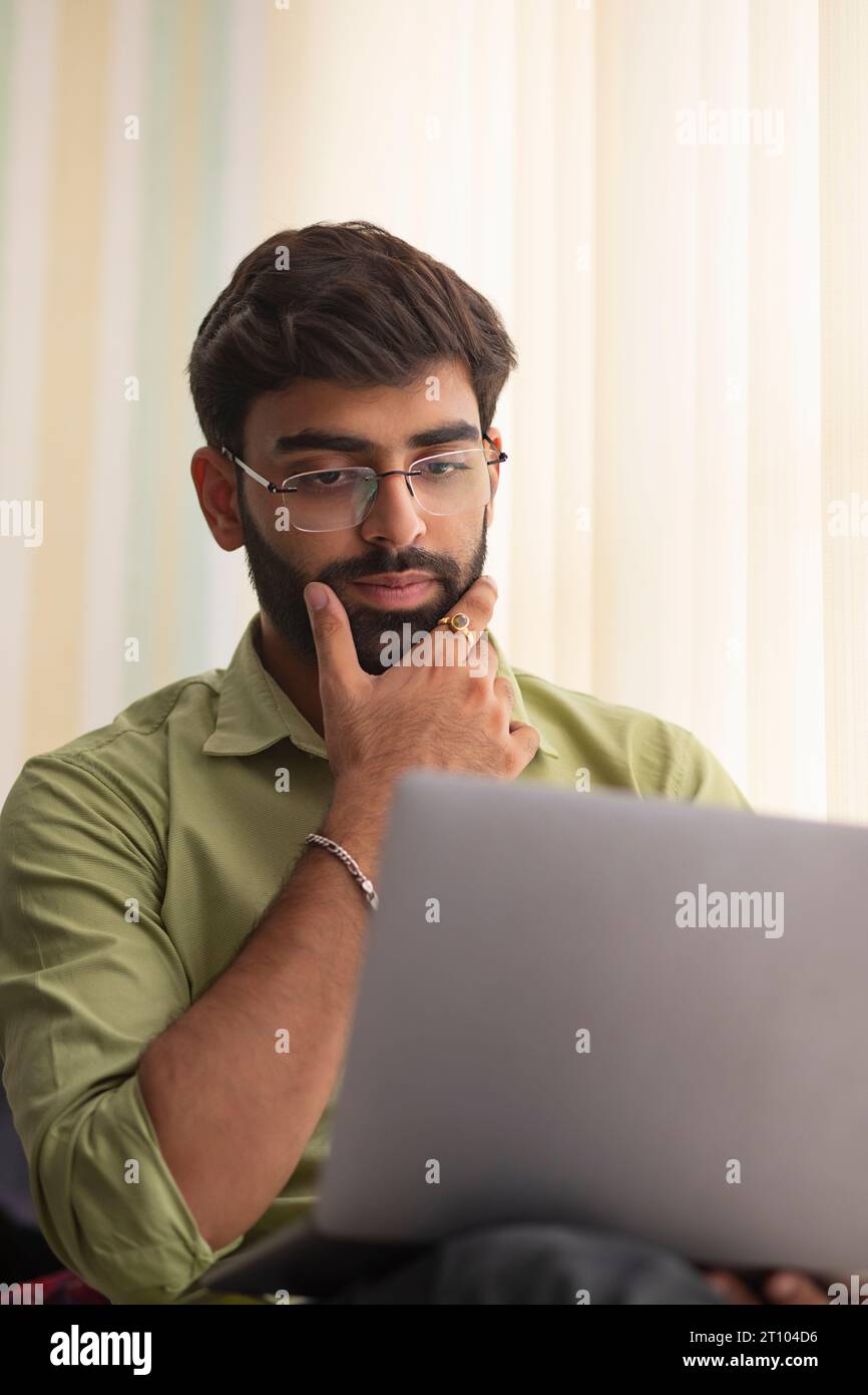 Indian man using laptop home hi-res stock photography and images - Alamy