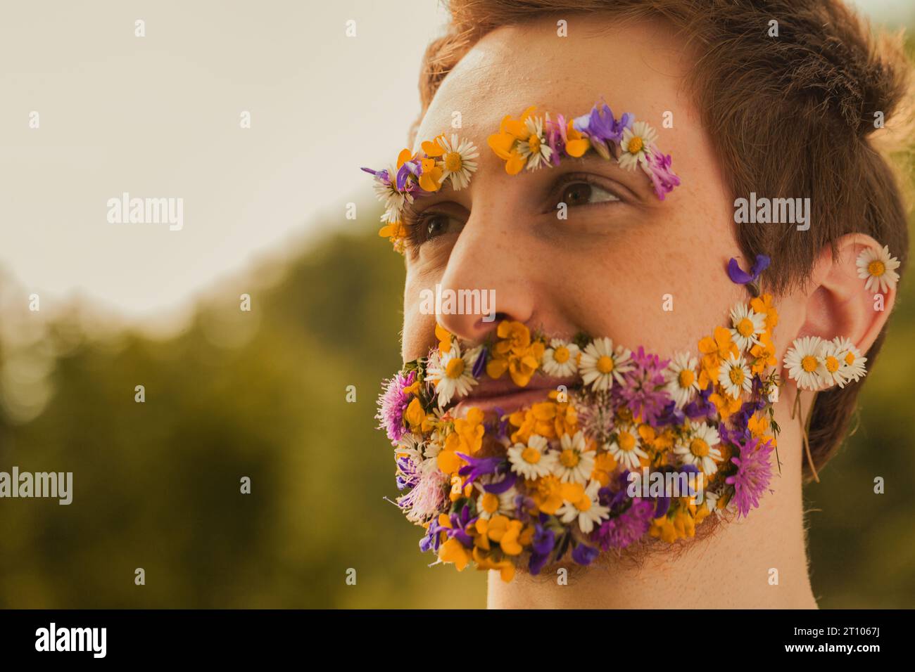 Trees form the backdrop for a redhead with a flowery visage. Such ...