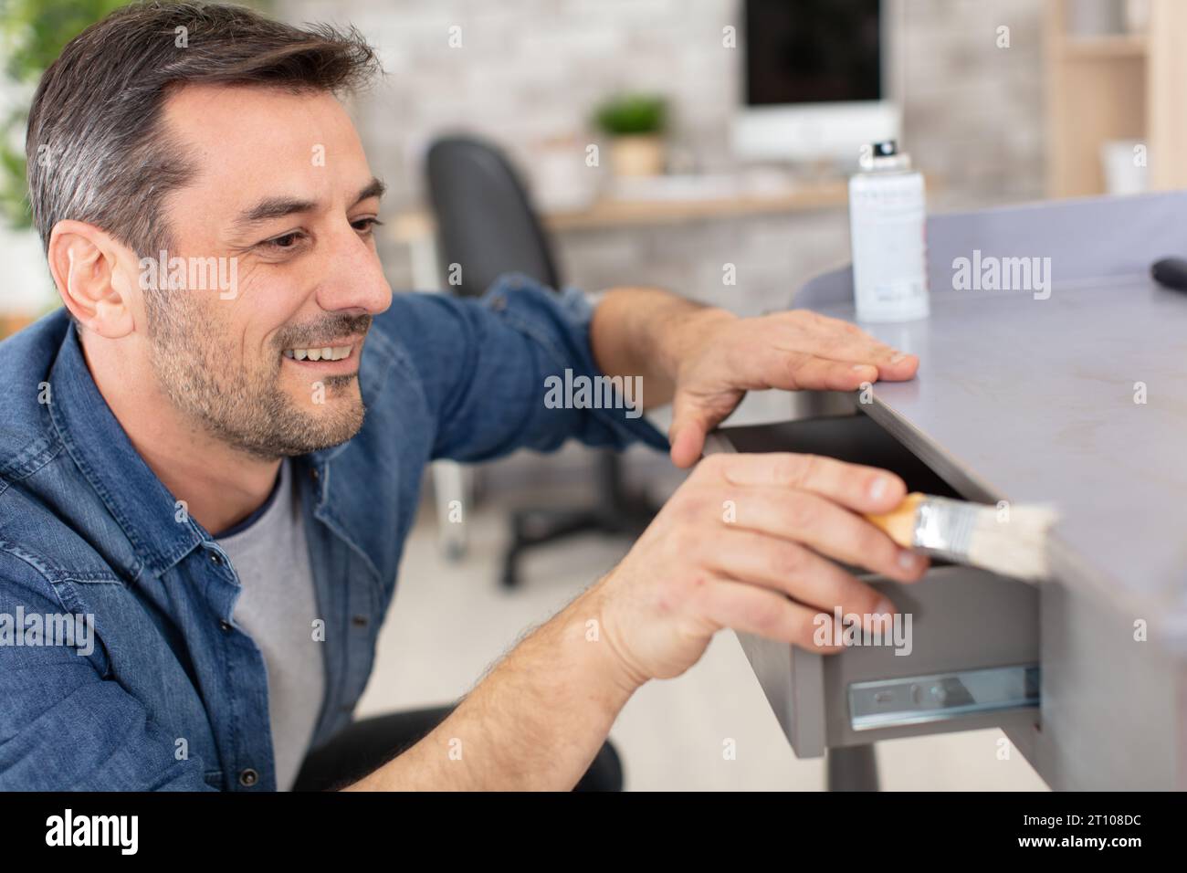 man repairing a furniture at home Stock Photo - Alamy
