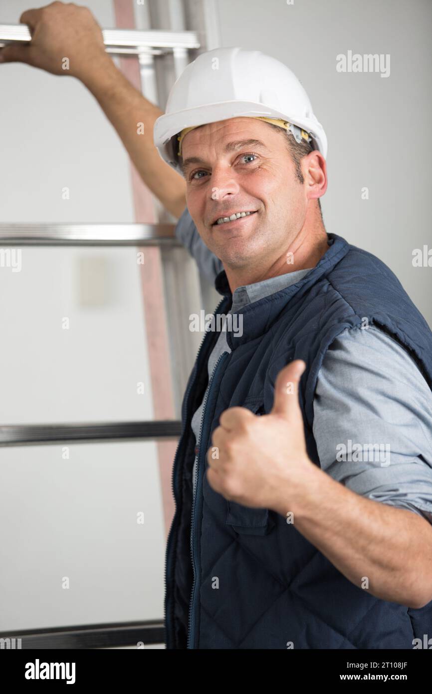 construction worker climbing a ladder Stock Photo - Alamy