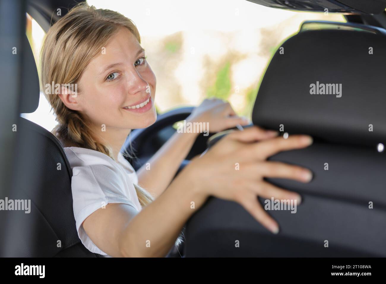 inbeauty female driver looking back in her car Stock Photo - Alamy