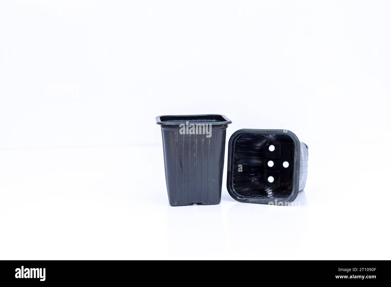 Black plastic flexible containers for seedlings and nursery isolated on ...