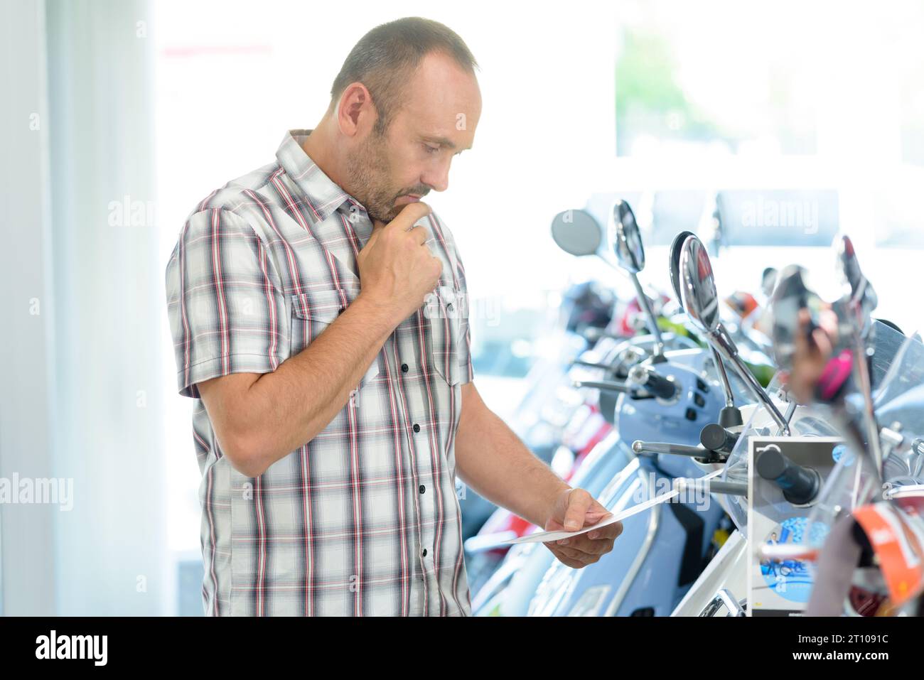 male customer browsing in motorcycle showroom Stock Photo - Alamy