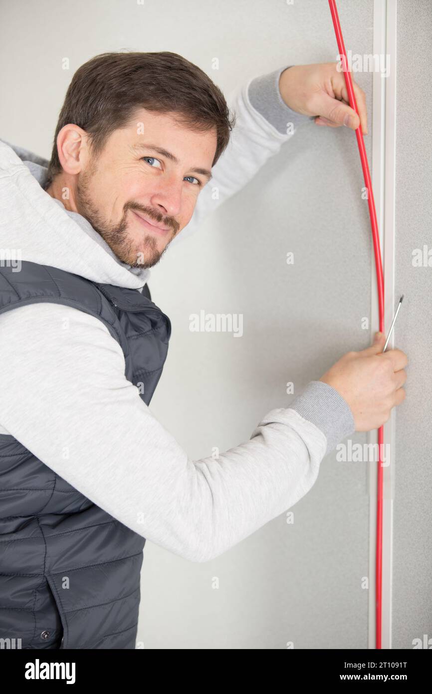 builder fitting wall cladding in a new build house Stock Photo - Alamy