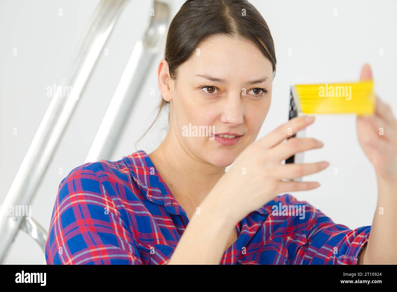 portrait of woman inspecting an object Stock Photo - Alamy