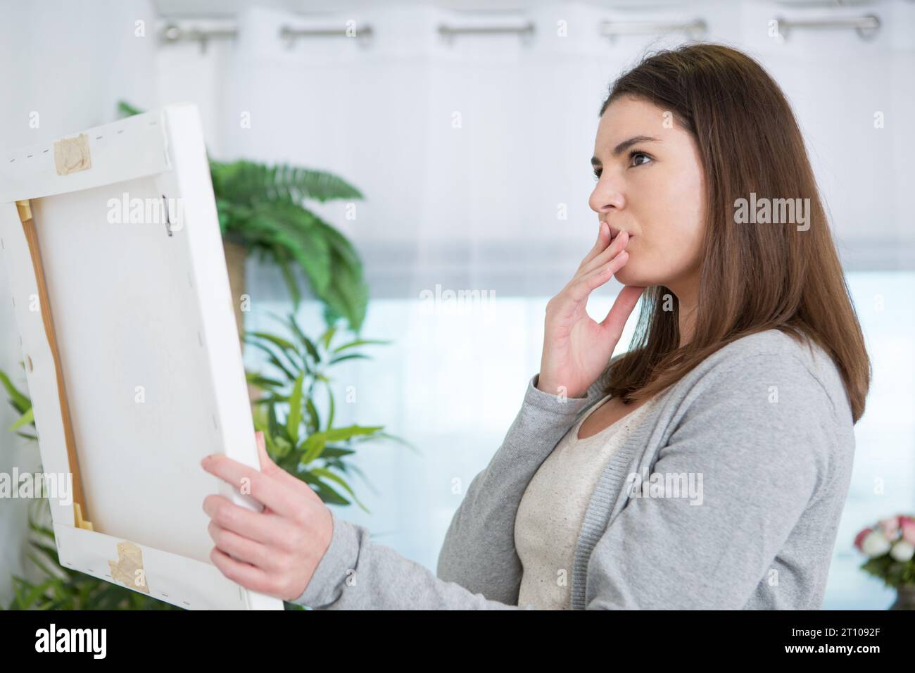 female artist thinking and looking at her illustration Stock Photo - Alamy
