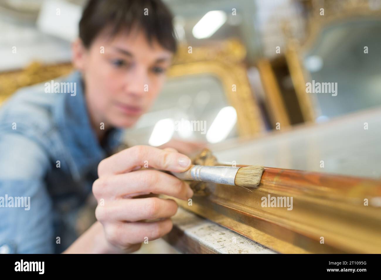 woman restoring an antique frame Stock Photo - Alamy