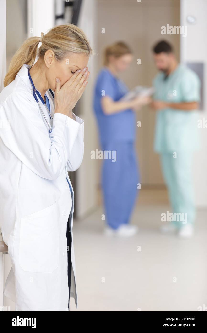 stressed female doctor standing in hospital Stock Photo - Alamy
