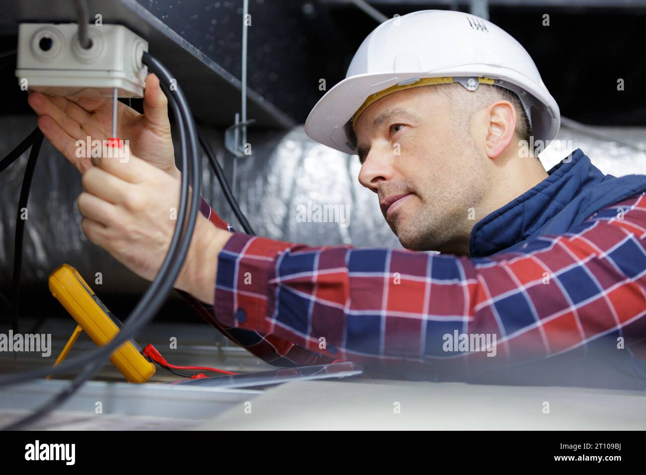 electrical worker wiring in ceiling Stock Photo - Alamy