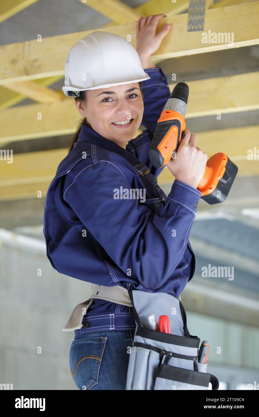 Young woman using electric power tool drill hi-res stock photography ...