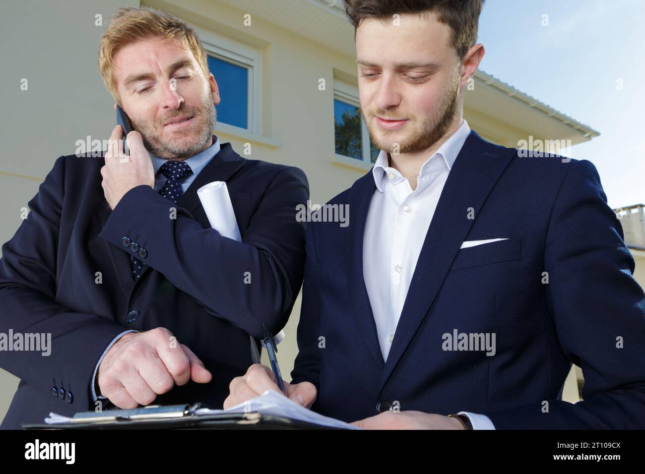 foreman outside office with construction plans Stock Photo - Alamy